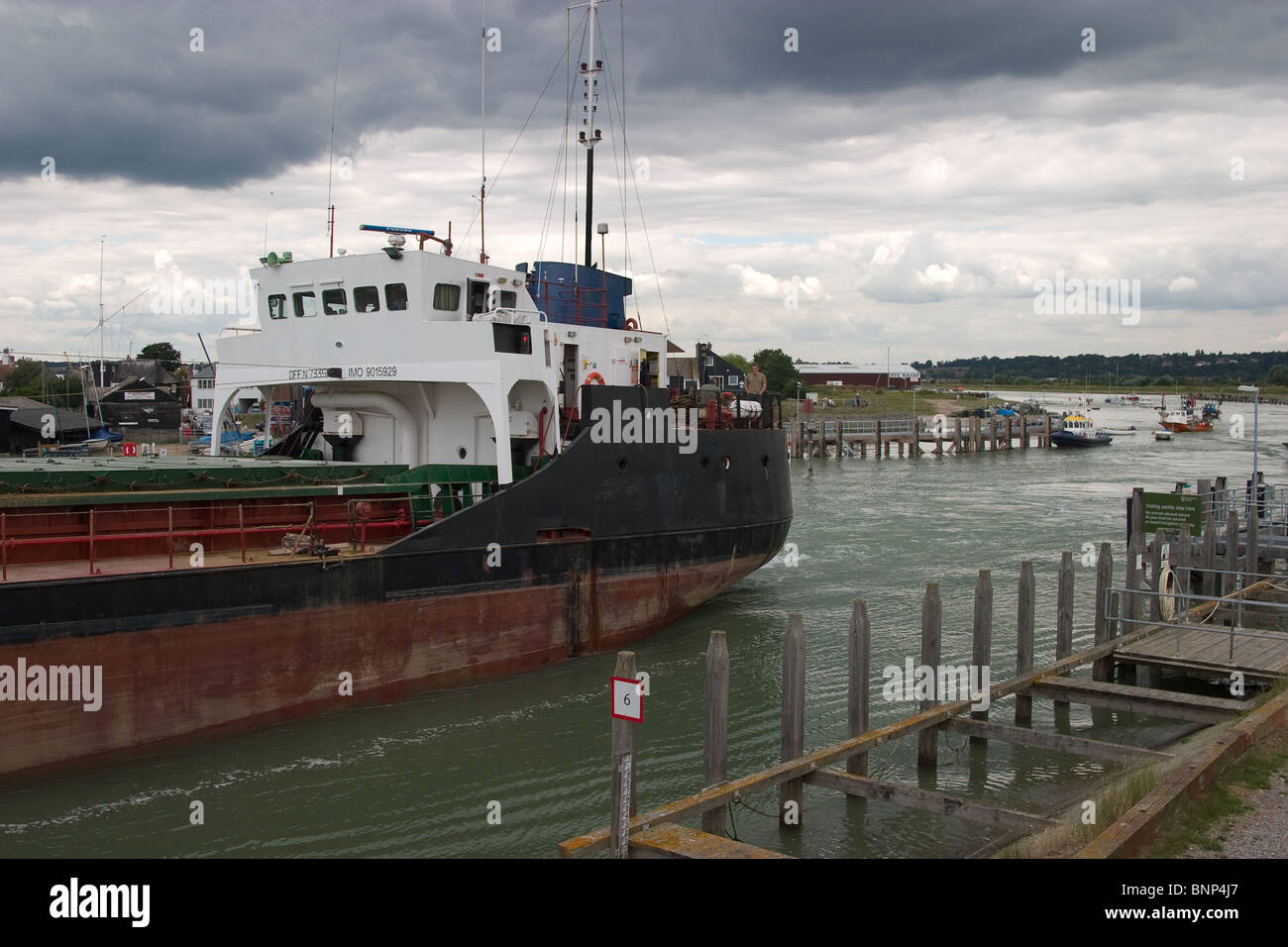 small cargo boat tanker river channel cloudy sky Stock Photo - Alamy