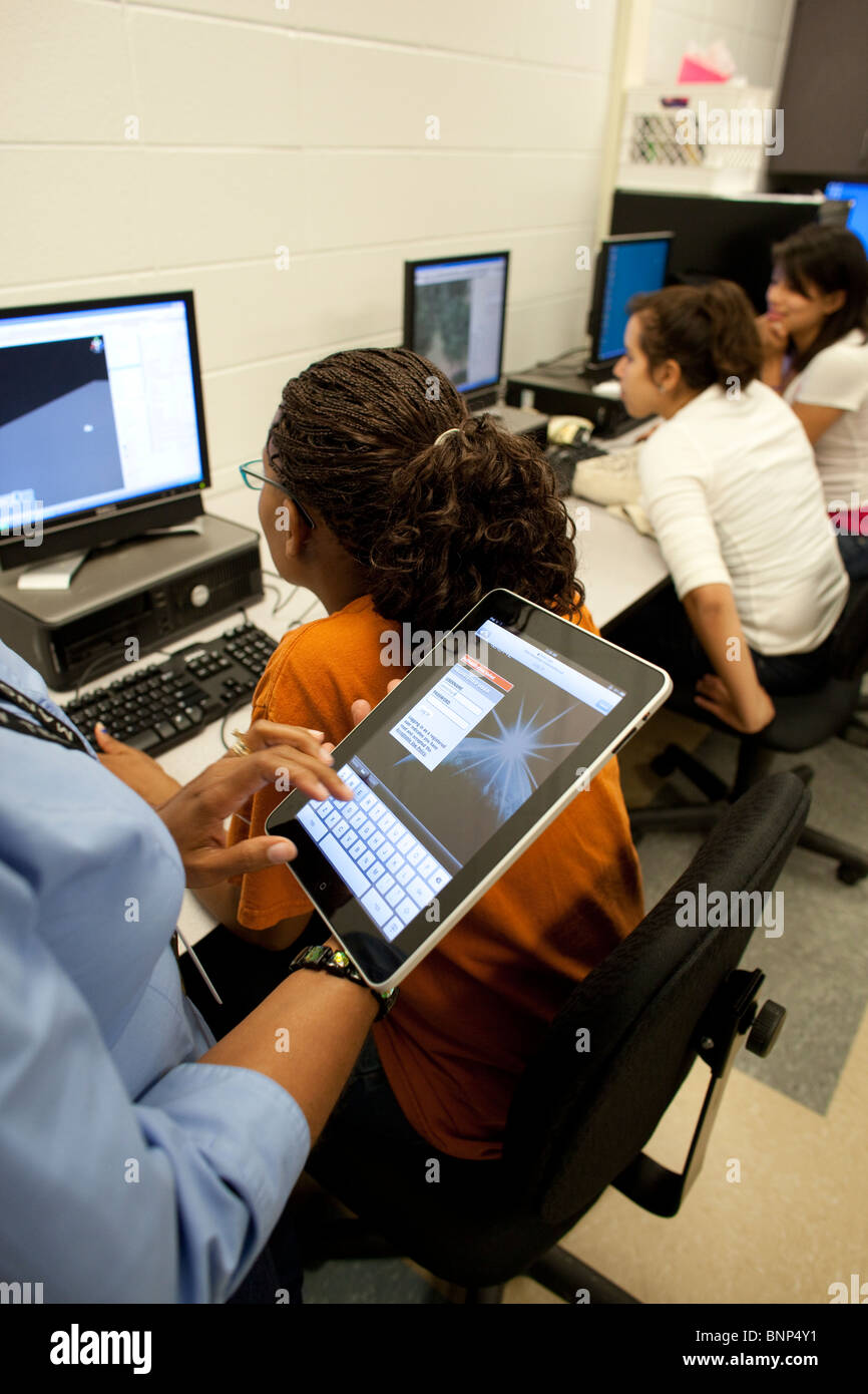 Female African-American teacher uses iPad in video production design ...