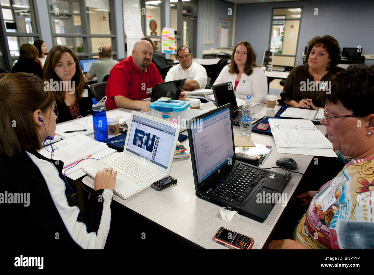 Teachers attending workshop use laptop computers during work session at ...