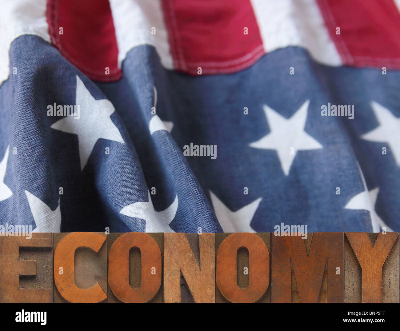 American flag with economy word in wood type Stock Photo - Alamy
