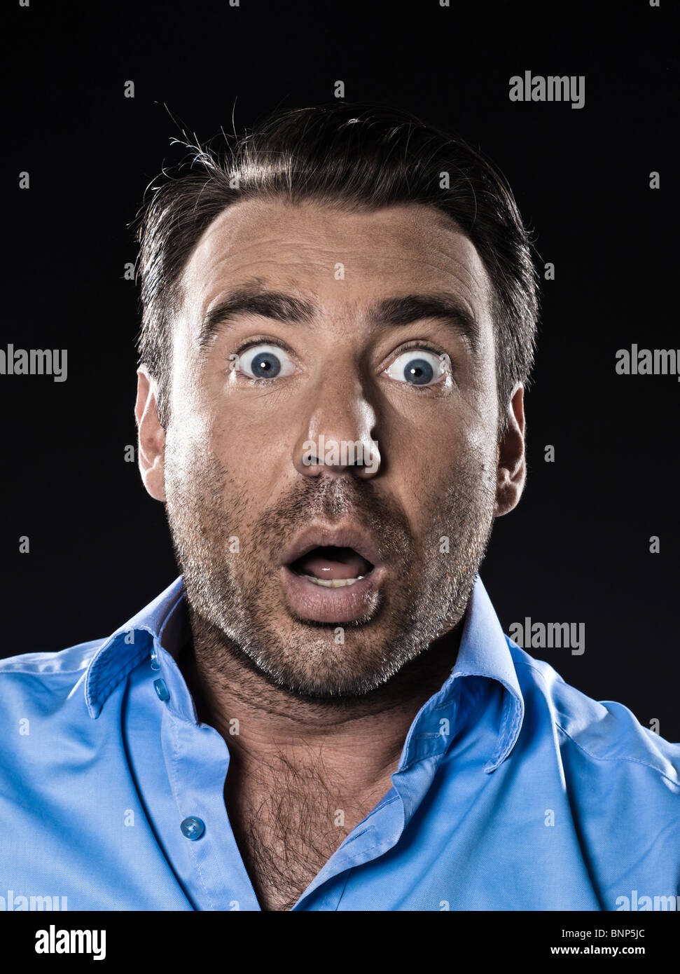 caucasian man unshaven portrait fear stuned isolated studio on black ...