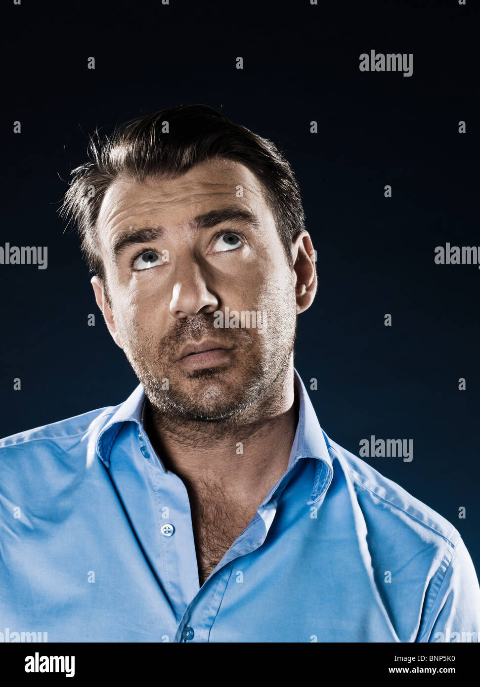 caucasian man unshaven pensive looking up portrait isolated studio on ...