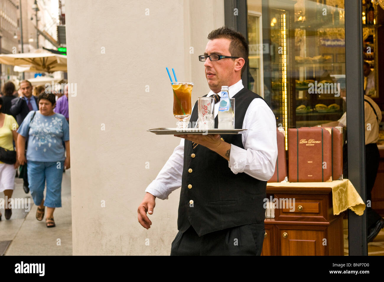 Waiter in Duomo square, Milan, Italy Stock Photo - Alamy