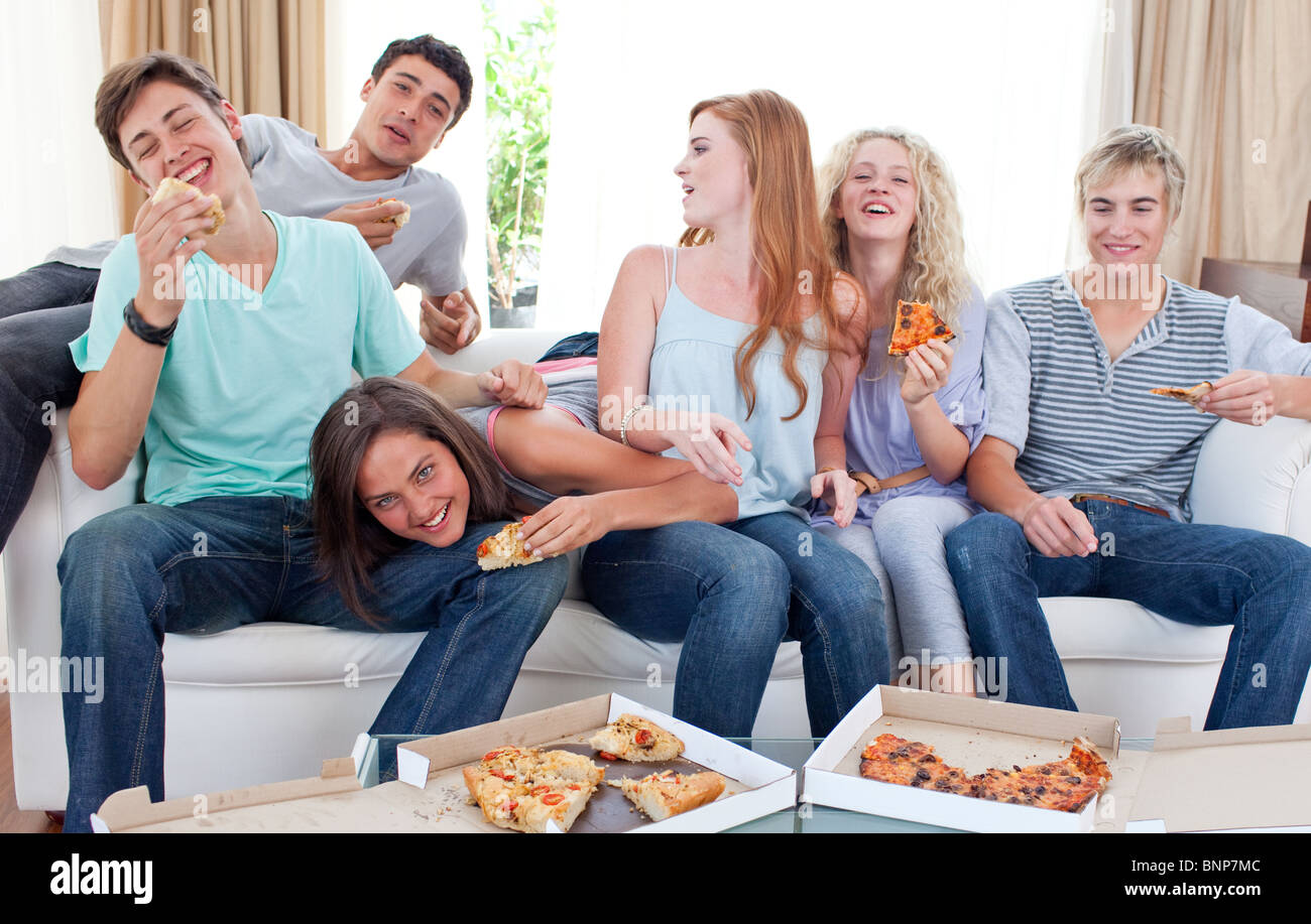 Teenagers eating pizza at home Stock Photo - Alamy