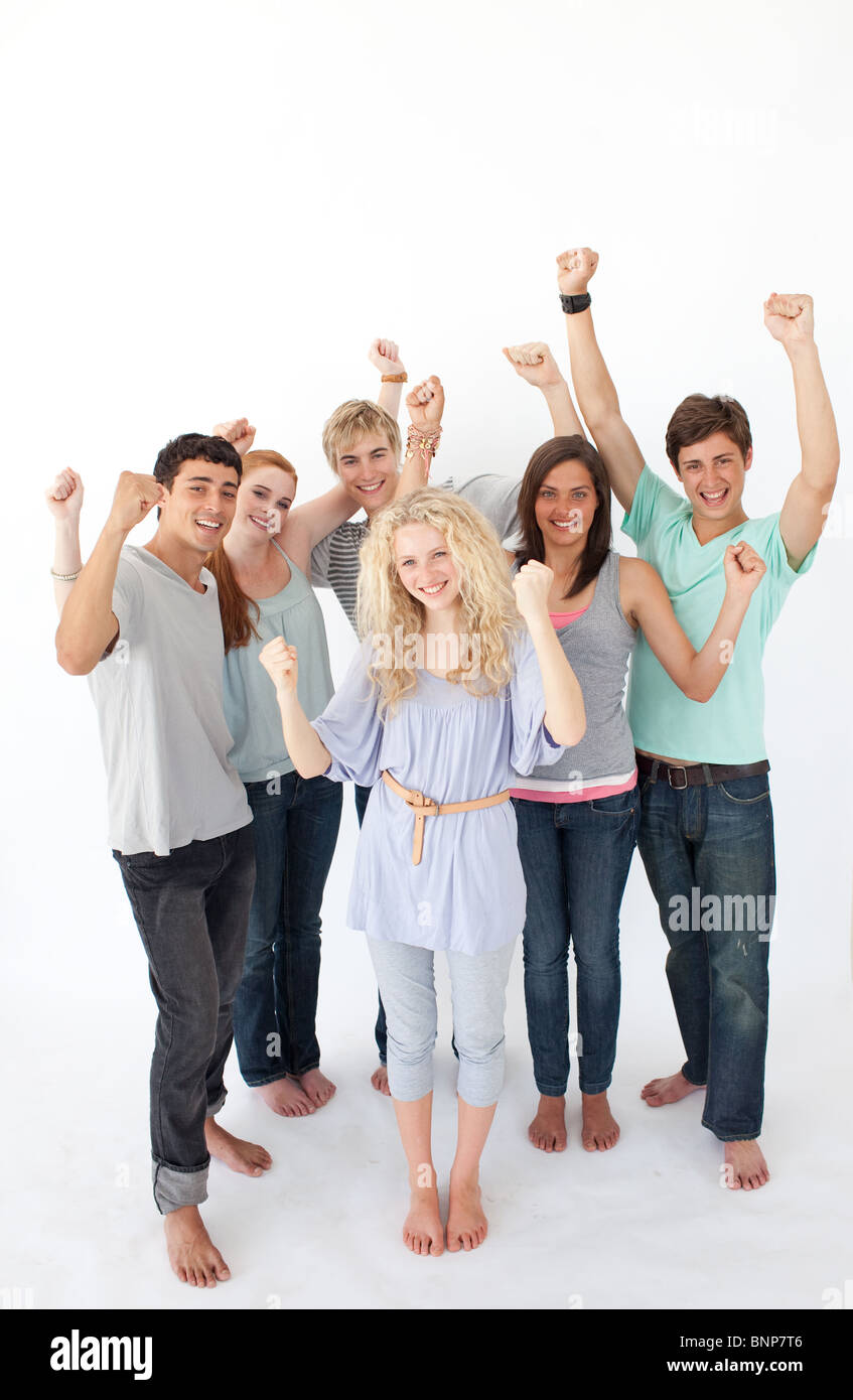 Successful friends standing against white background Stock Photo - Alamy