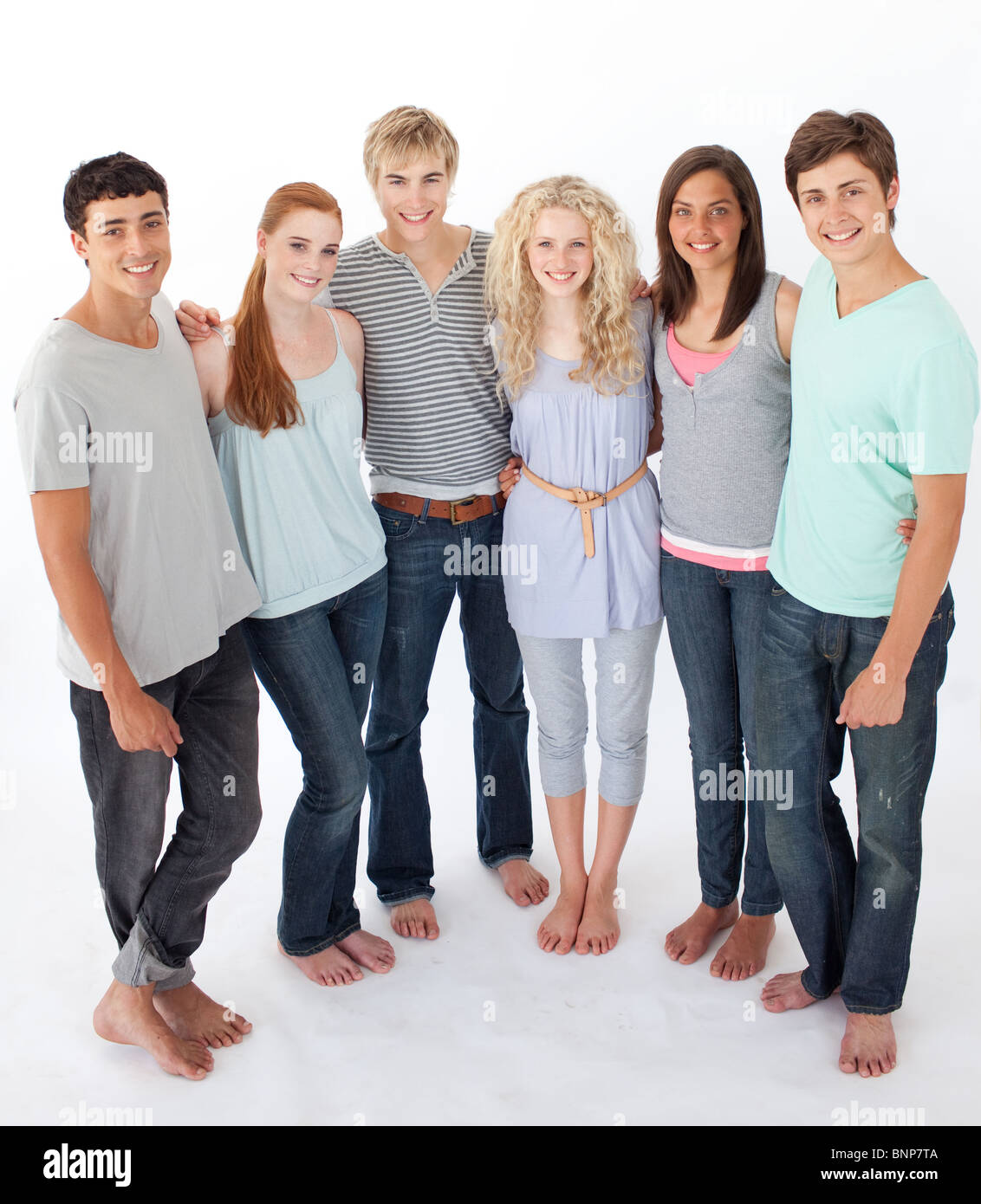 Group of friends standing against white background Stock Photo - Alamy