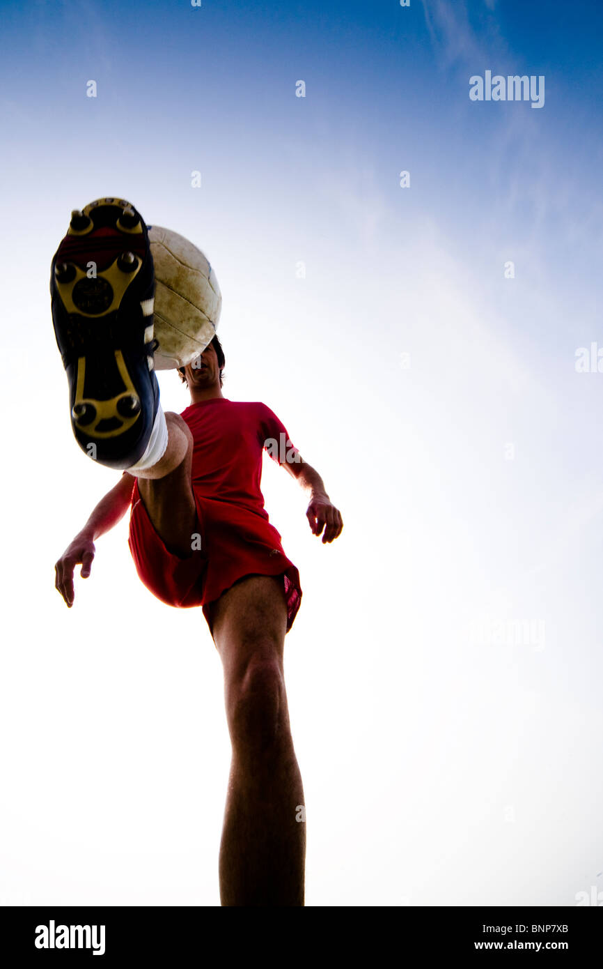 Soccer player kicking ball, low angle view Stock Photo - Alamy