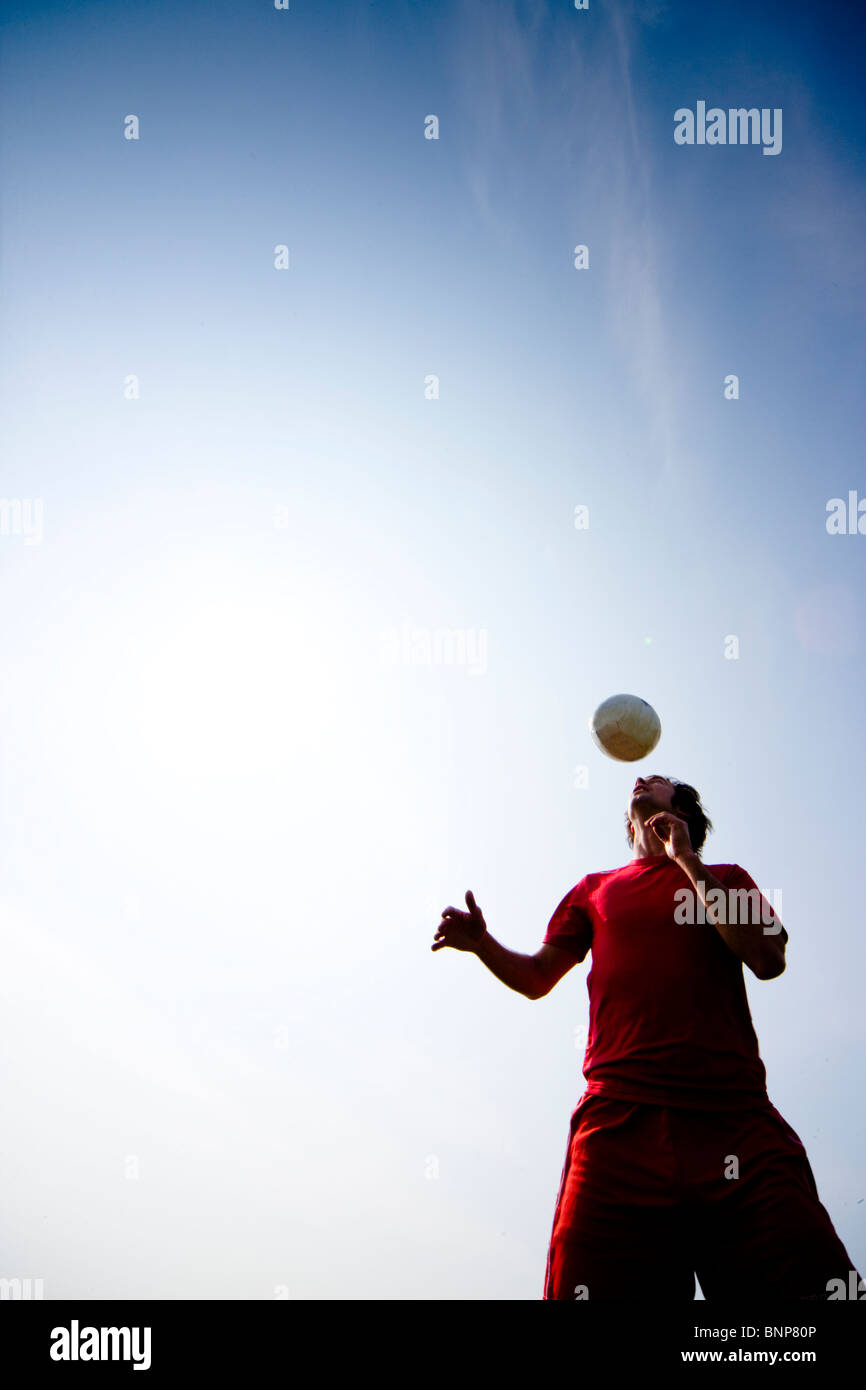 Soccer player heading ball Stock Photo - Alamy