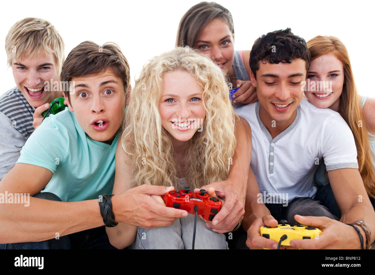 Excited teenagers playing video games in the living-room Stock Photo ...