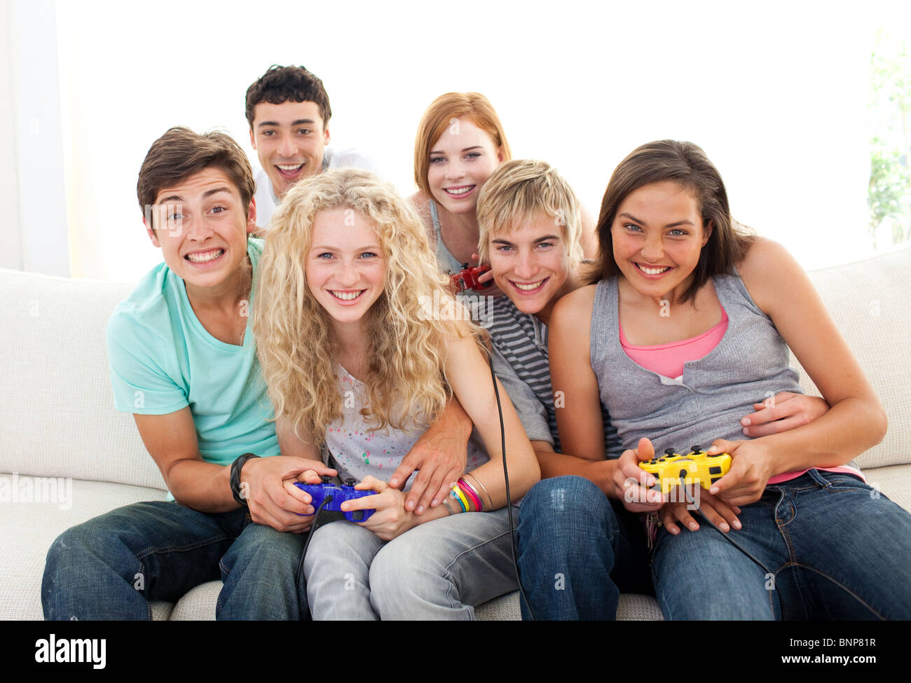 Friends playing video games in the living-room Stock Photo - Alamy