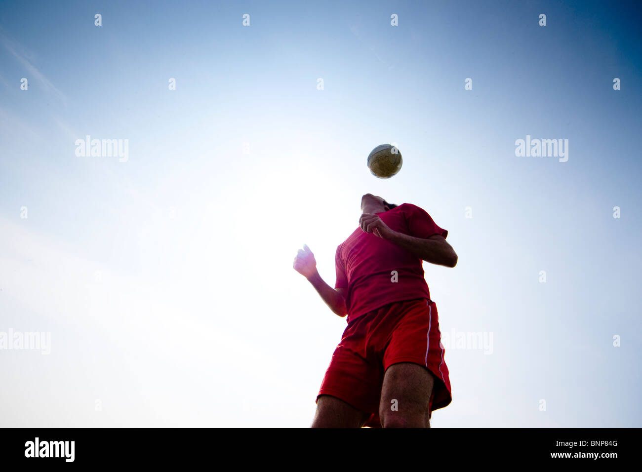 Soccer player heading ball Stock Photo - Alamy