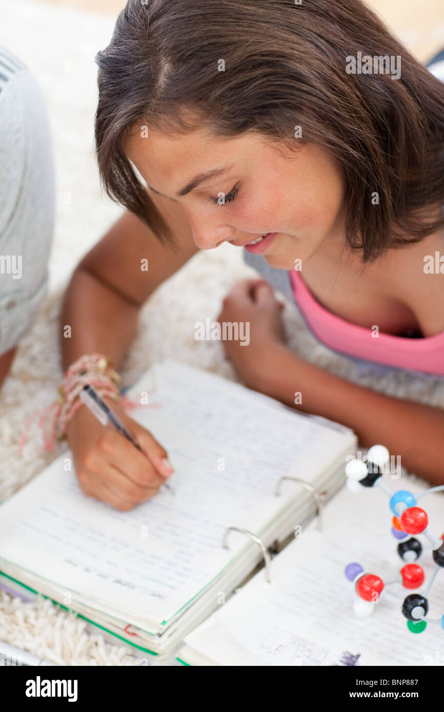 Beautiful teenager doing homework on the floor Stock Photo - Alamy