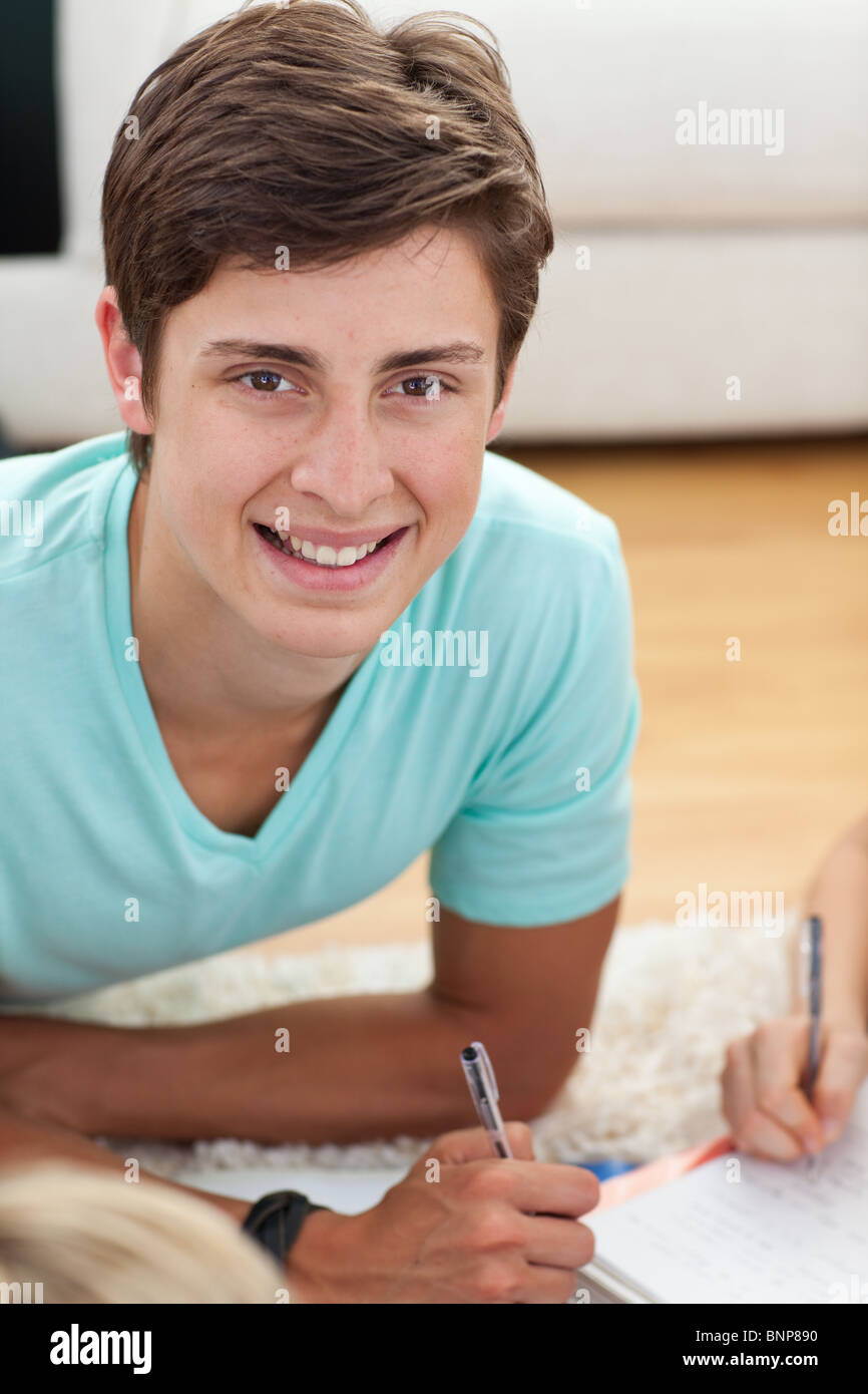 Portrait of a teen guy doing homework Stock Photo - Alamy