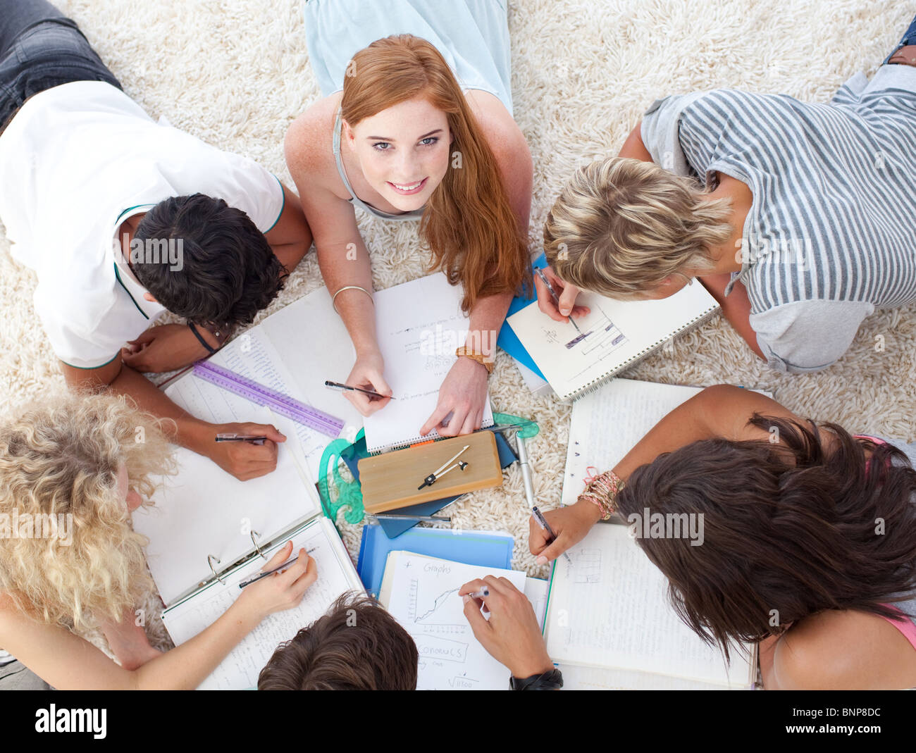 Teens doing homework together Stock Photo - Alamy