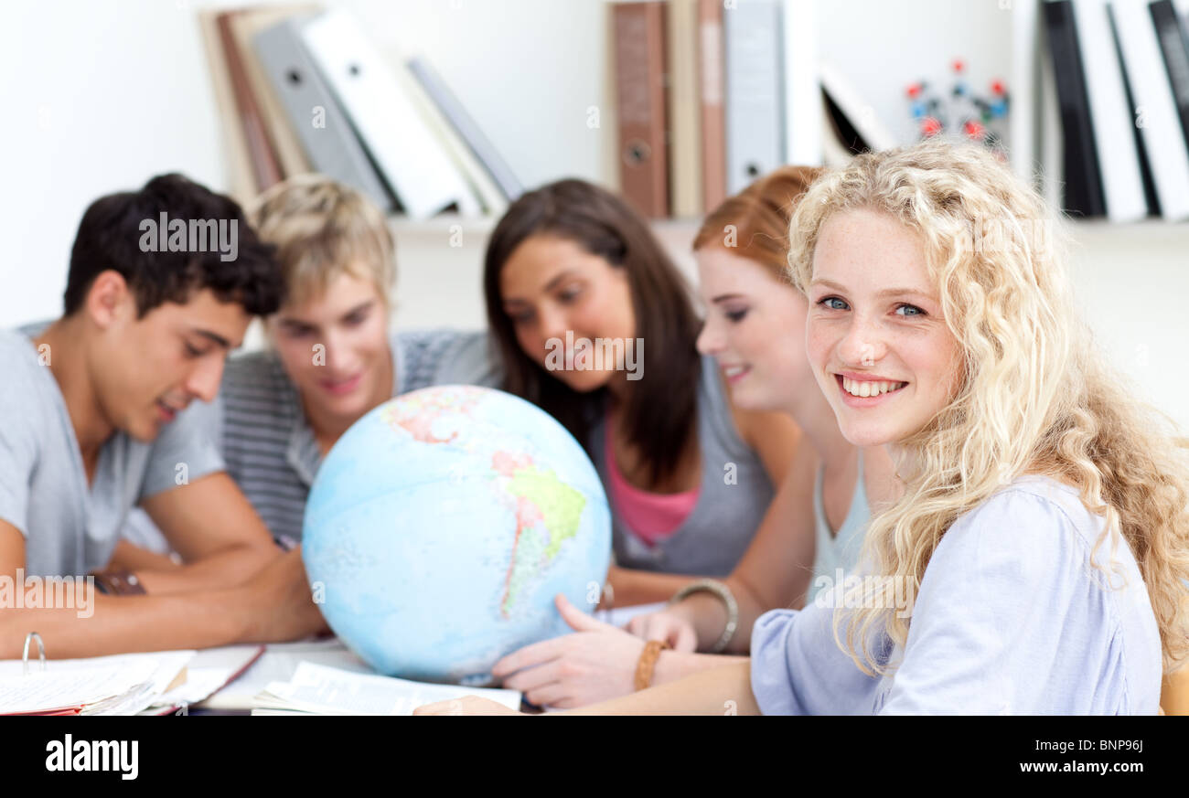 Teenagers in a library working with a terrestrial globe Stock Photo - Alamy