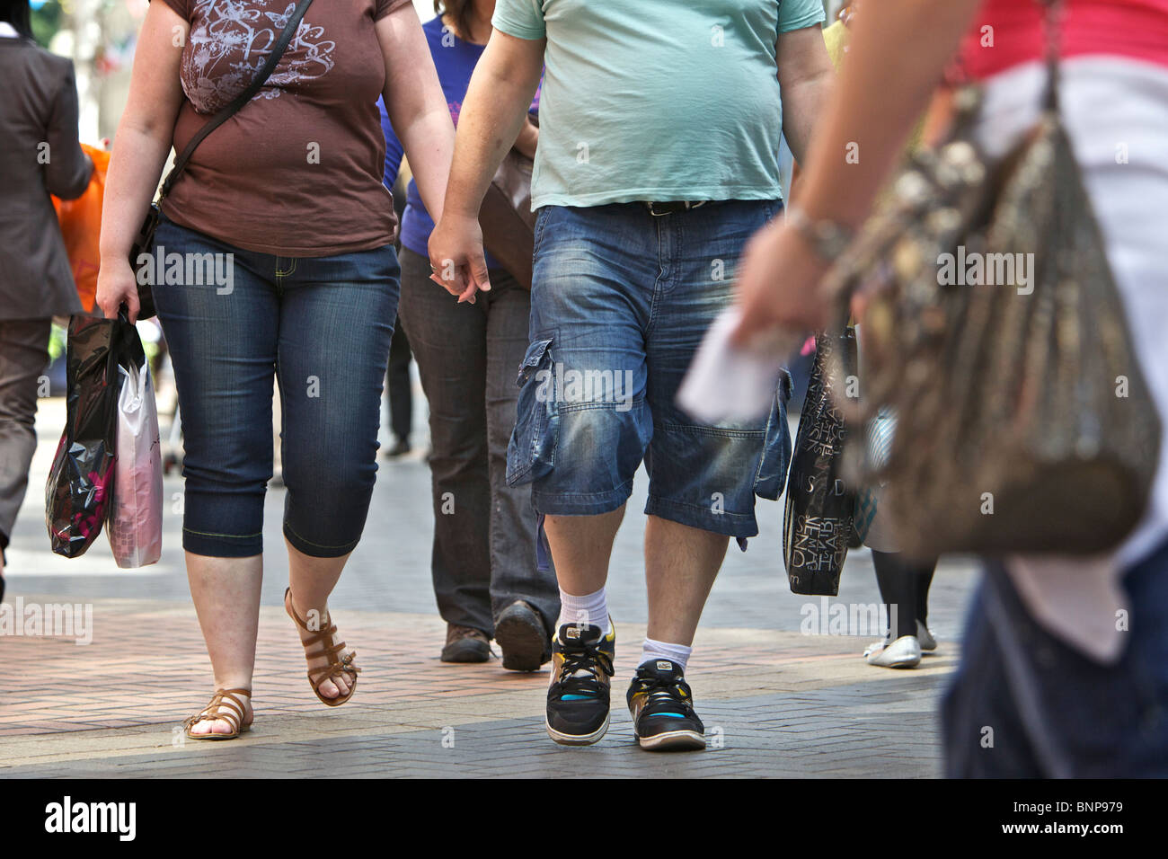 Overweight people on shopping street Stock Photo - Alamy