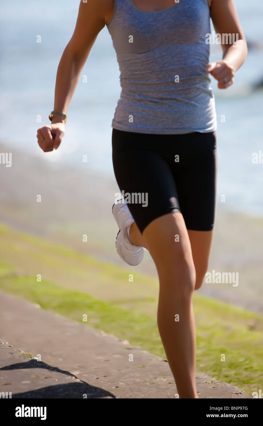 Woman running, headless Stock Photo - Alamy