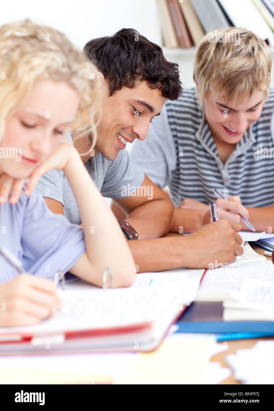 Teenagers studying in the library Stock Photo - Alamy