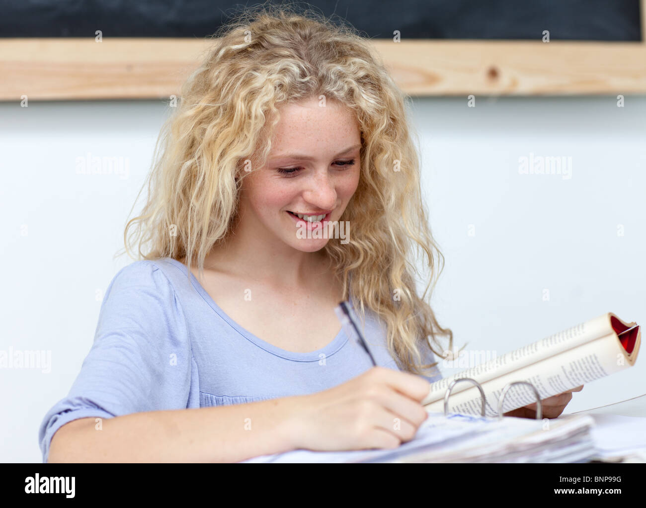 Portrait of a cute teen girl studying Stock Photo - Alamy