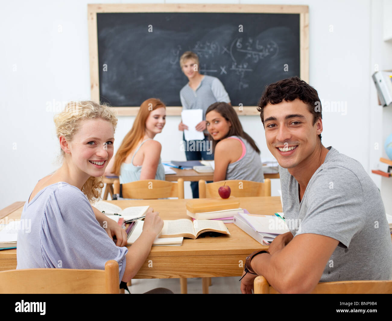 Teenagers studying together in a class Stock Photo - Alamy