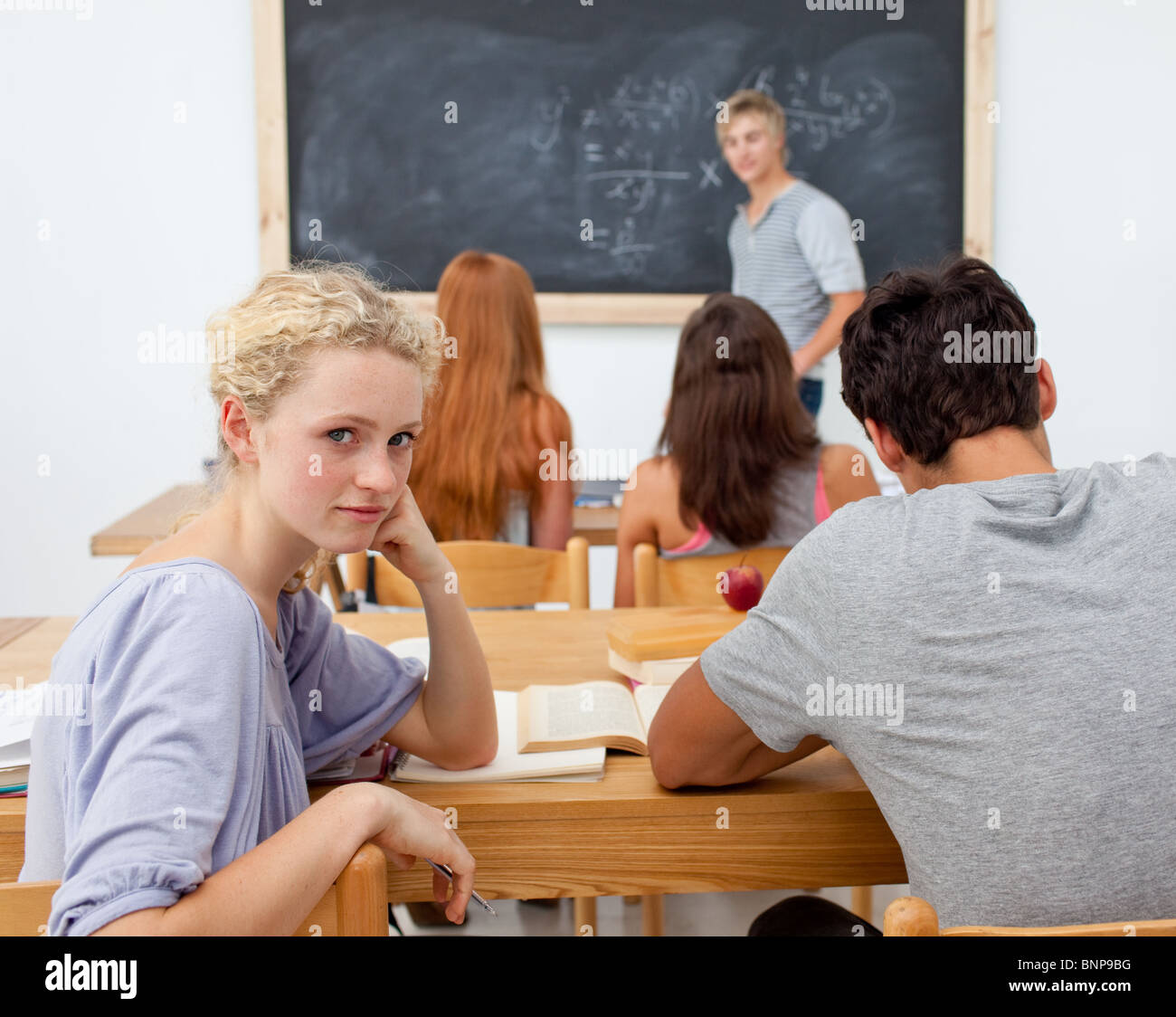 Teenagers studying together in a class Stock Photo - Alamy