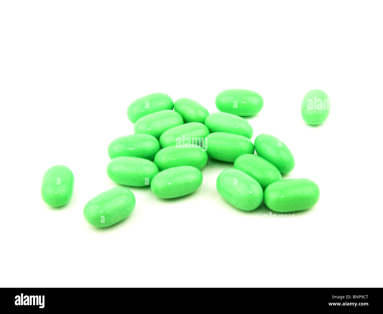 Green candies on white background Stock Photo - Alamy