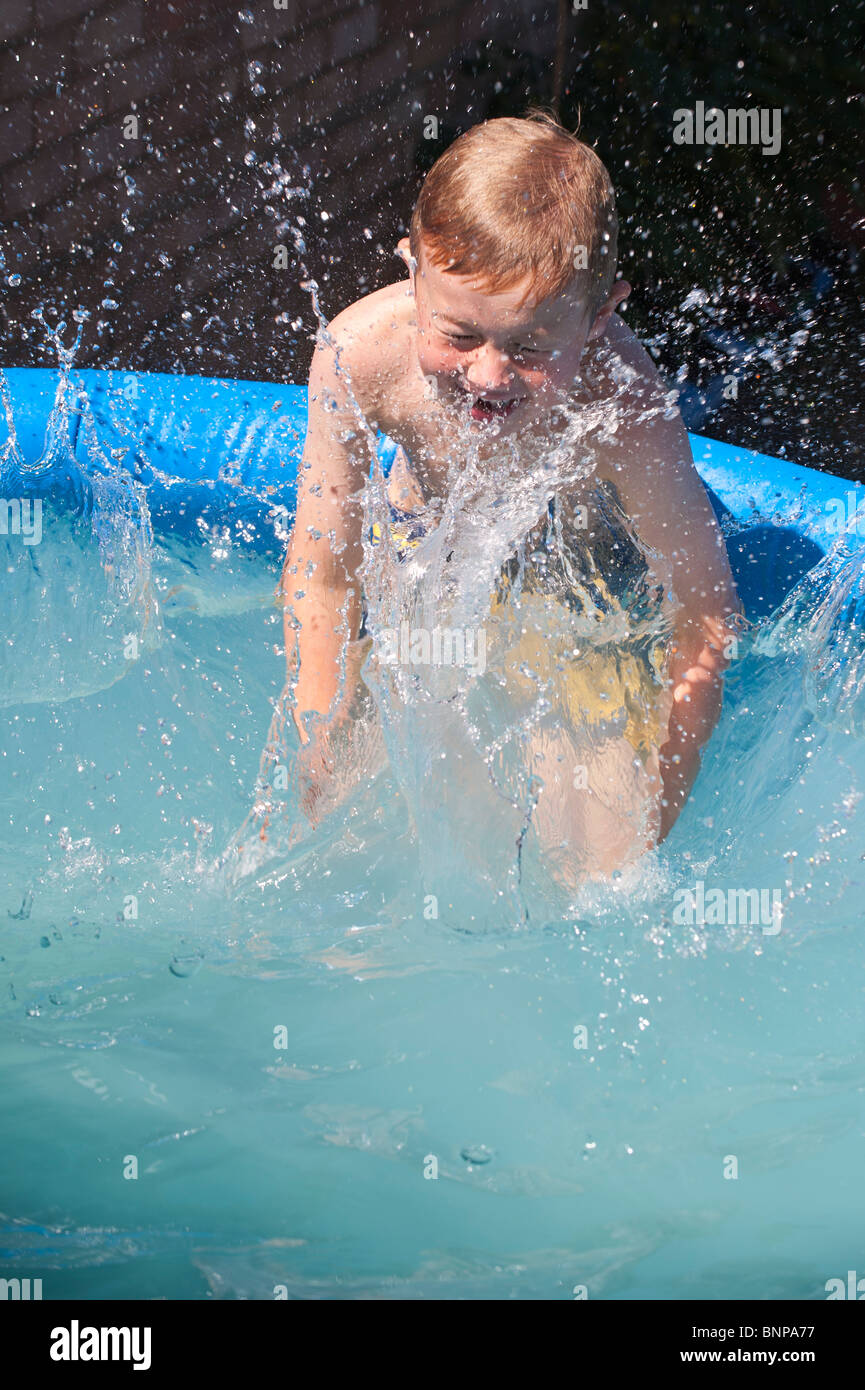 A MODEL RELEASED six year old boy splashing and showing movement in a ...