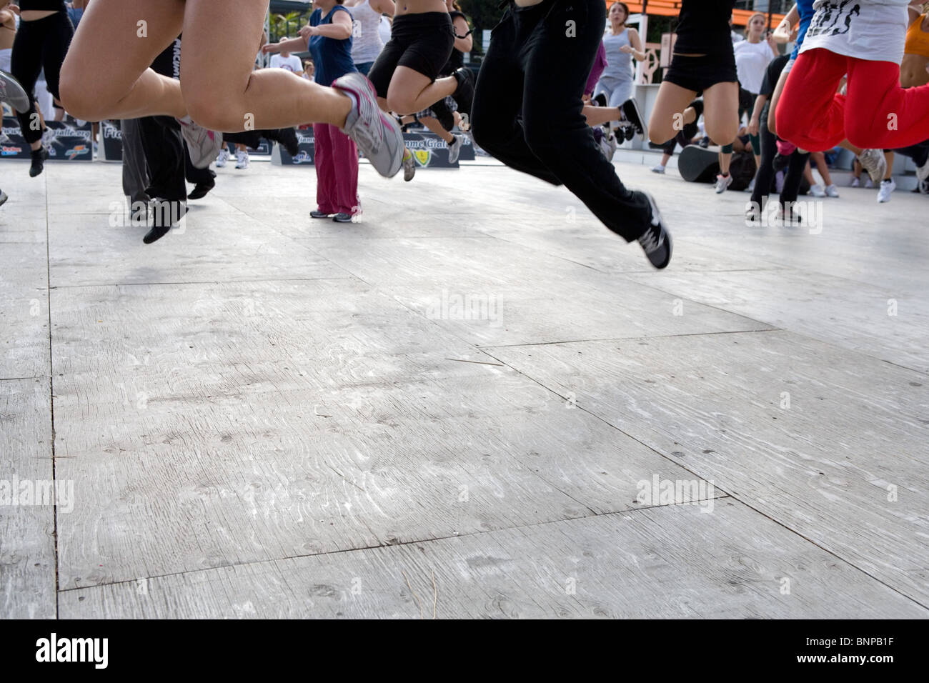 group of people at aerobics gym fitness class. legs jump jumping ...