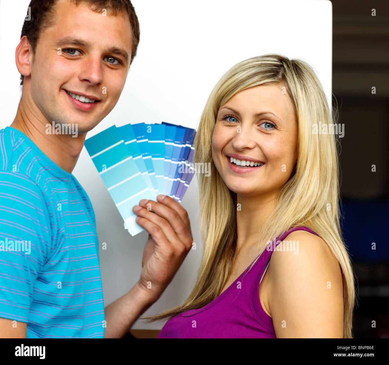 Couple chosing colours for painting house Stock Photo - Alamy