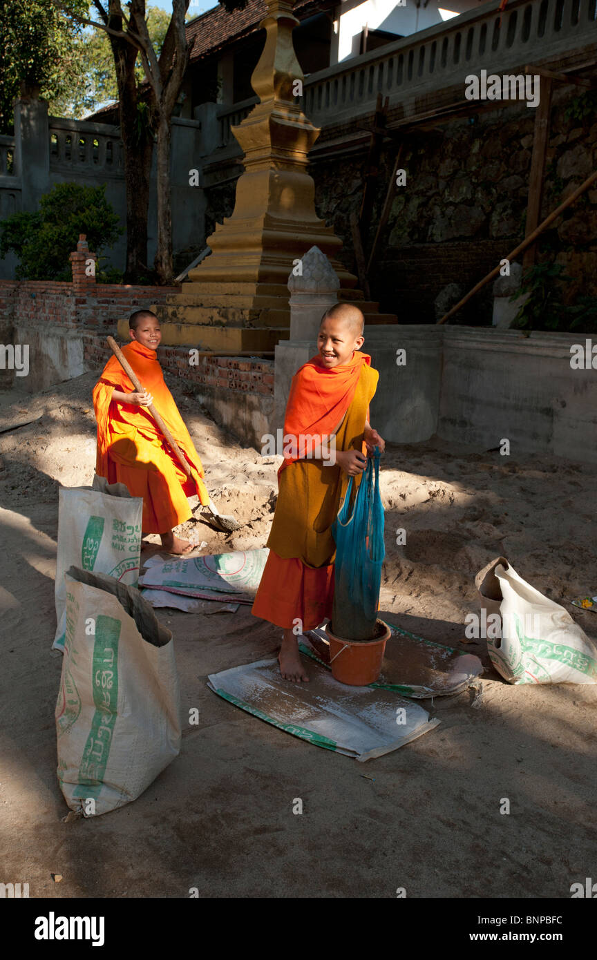 Young novice Buddhist monks help with the maintenance of their temple ...