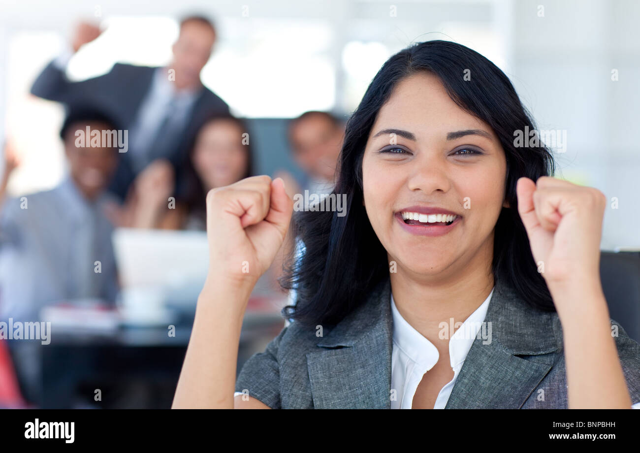 Businesswoman celebrating a success in office Stock Photo - Alamy