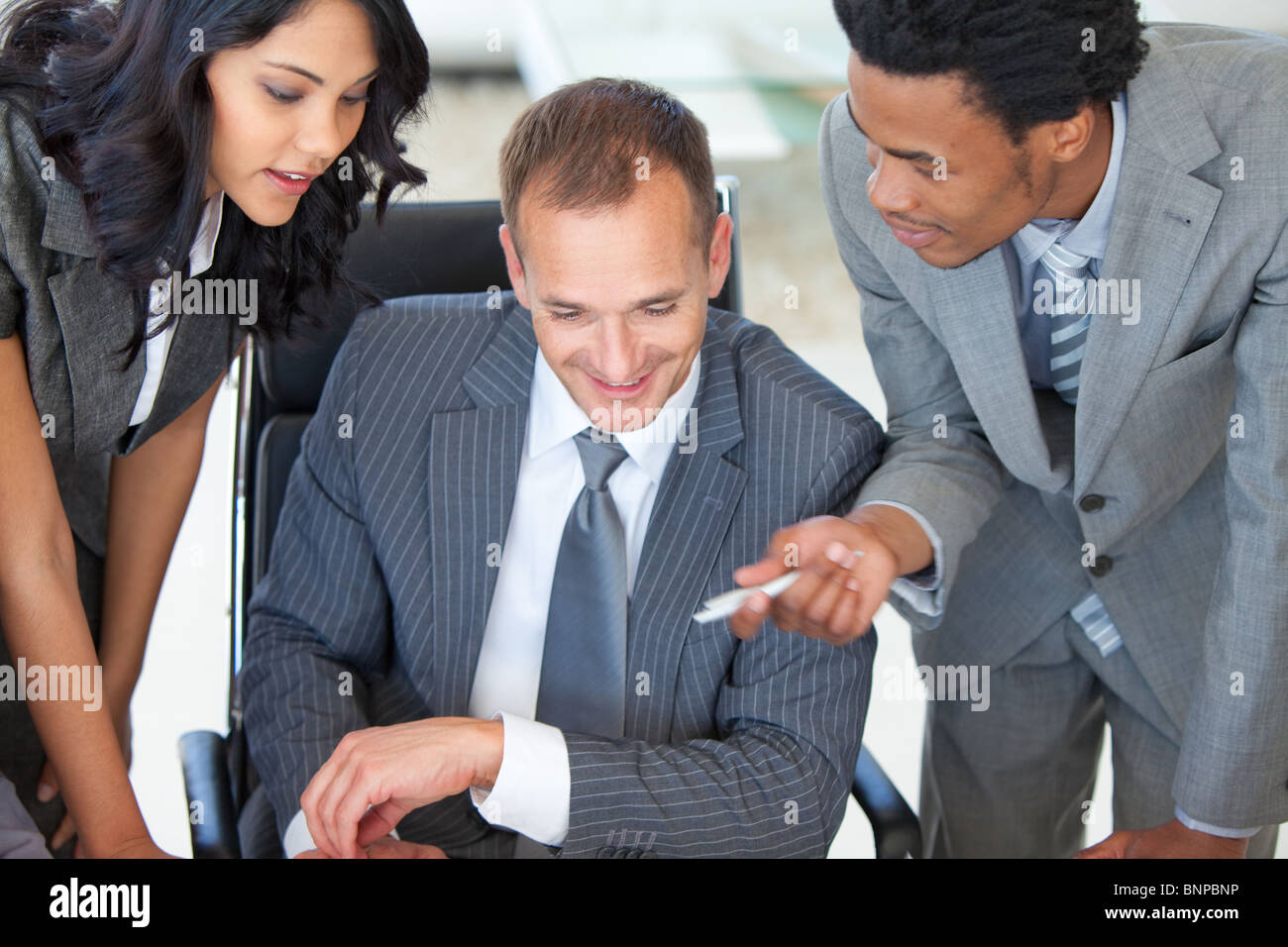 Manager with employees working in office Stock Photo - Alamy