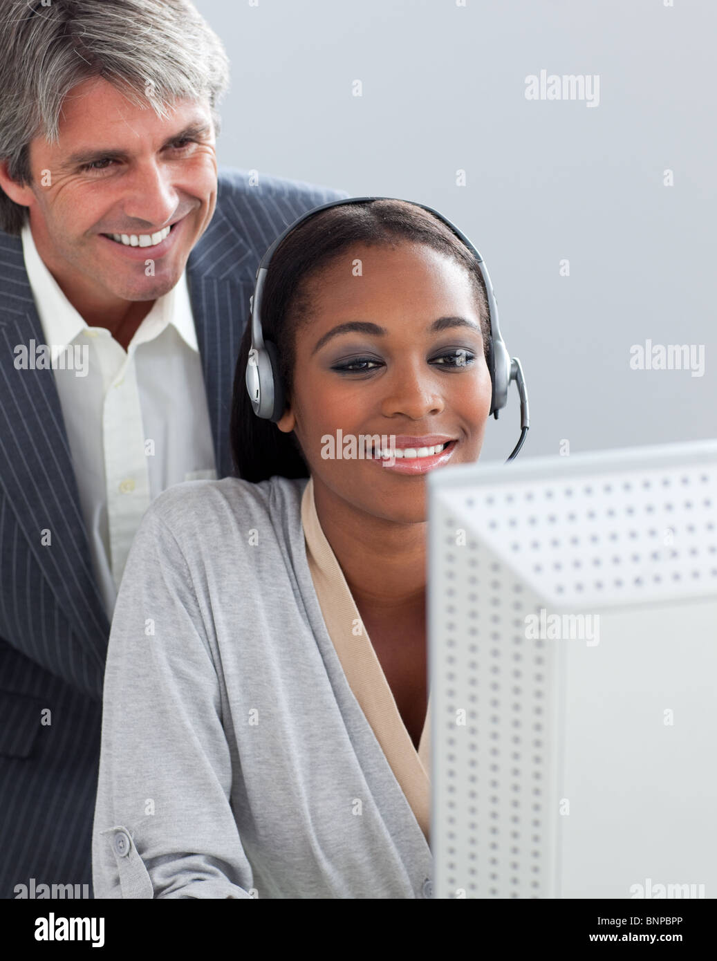 Smiling manager checking his employee's work Stock Photo - Alamy