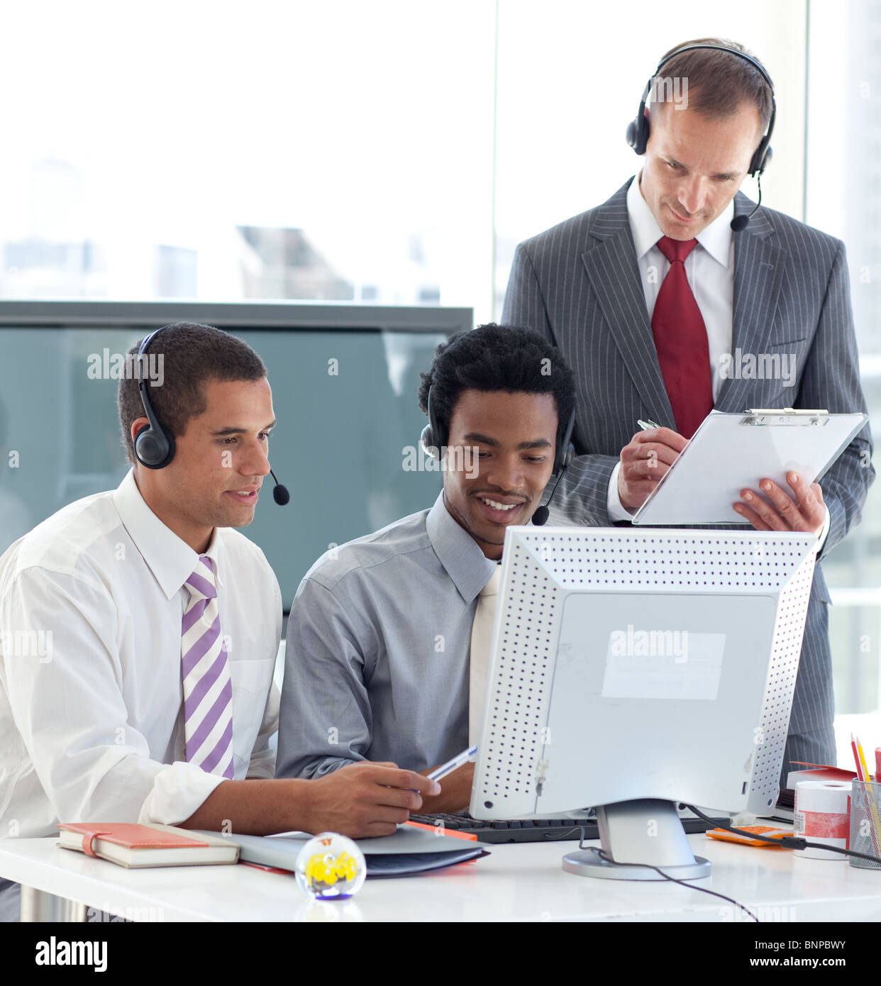 Manager and businessmen working in call center Stock Photo - Alamy