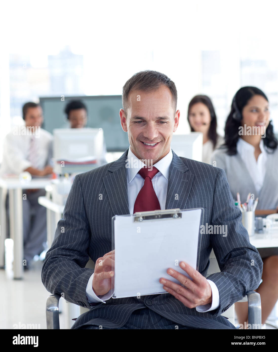 Male manager writing notes in a call center Stock Photo - Alamy