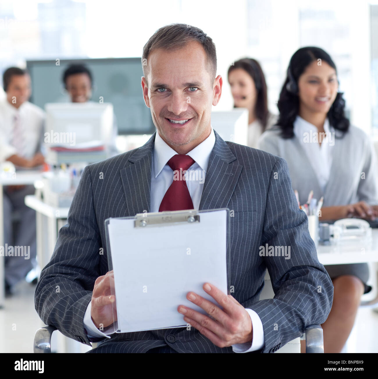 Male manager taking notes in a call center Stock Photo - Alamy