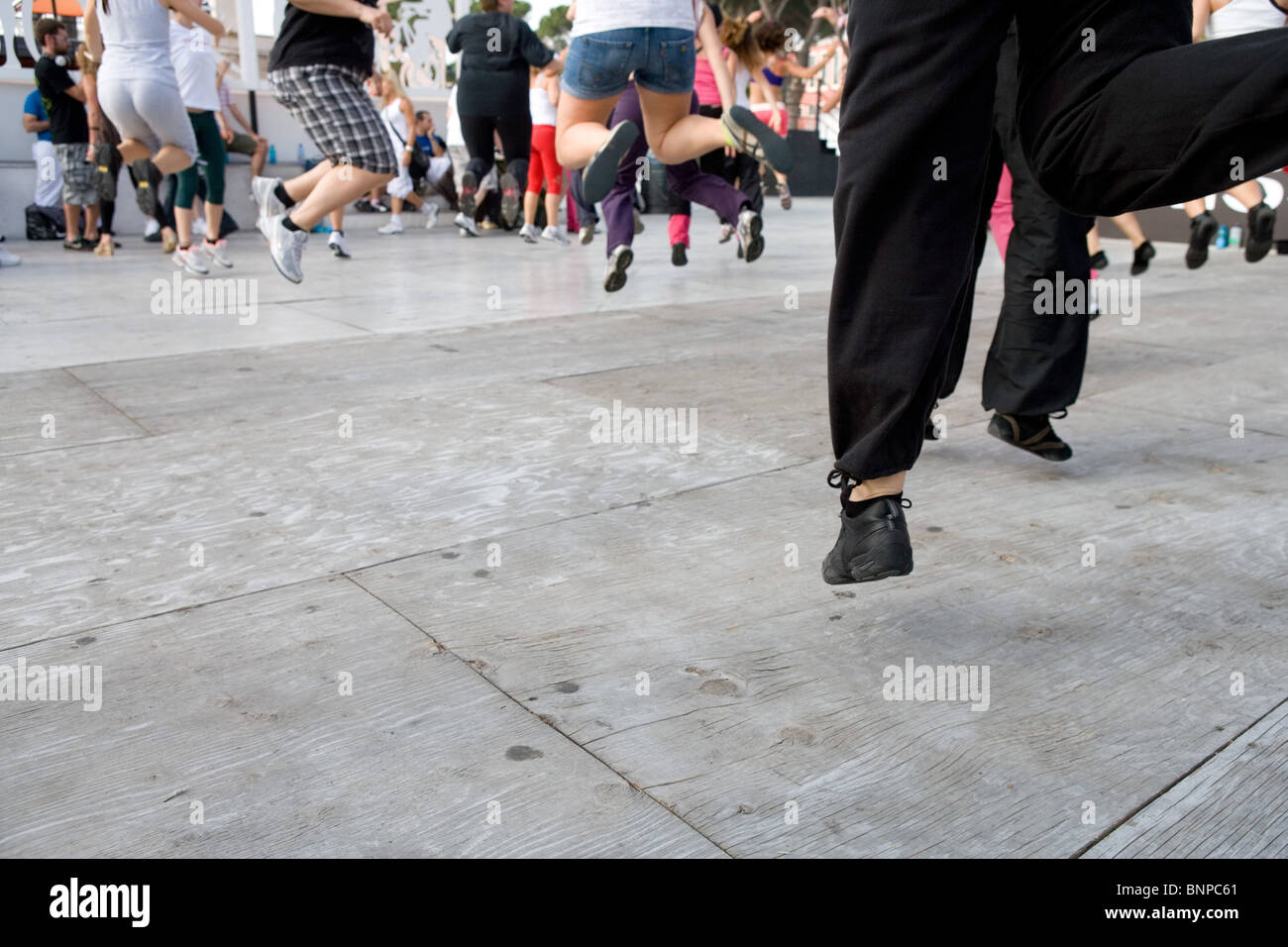 group of people at aerobics gym fitness class. legs jump jumping ...