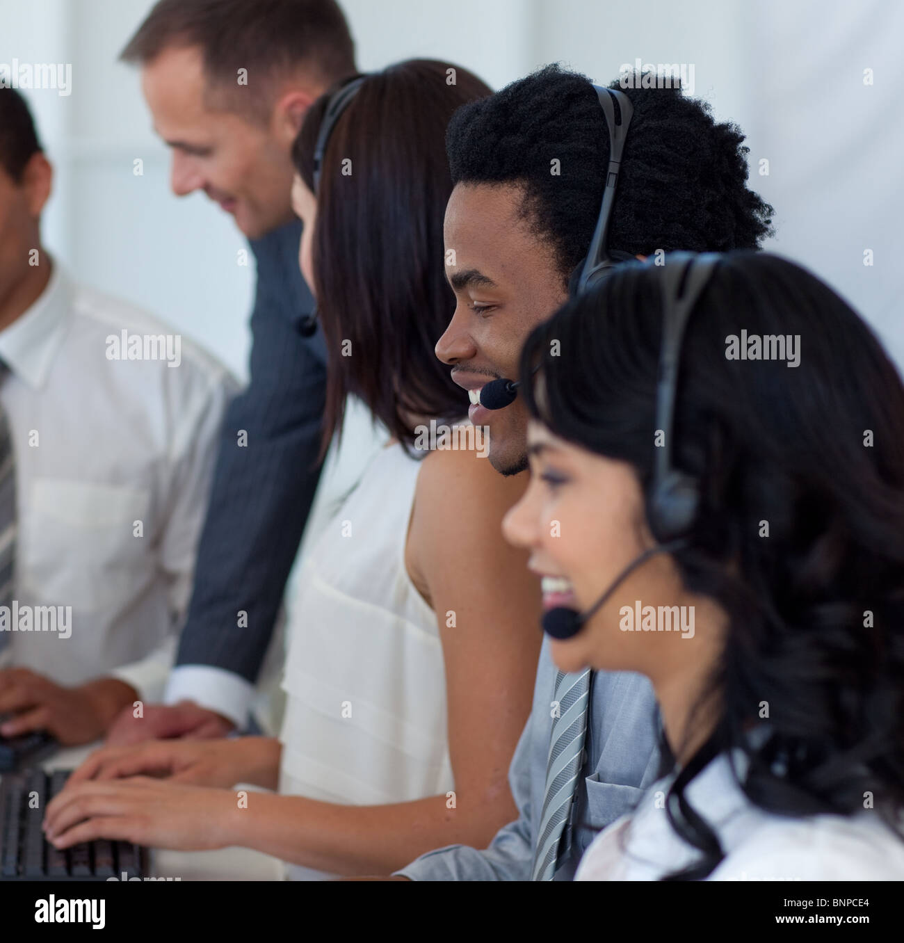 Business team working in a call center with a manager Stock Photo - Alamy