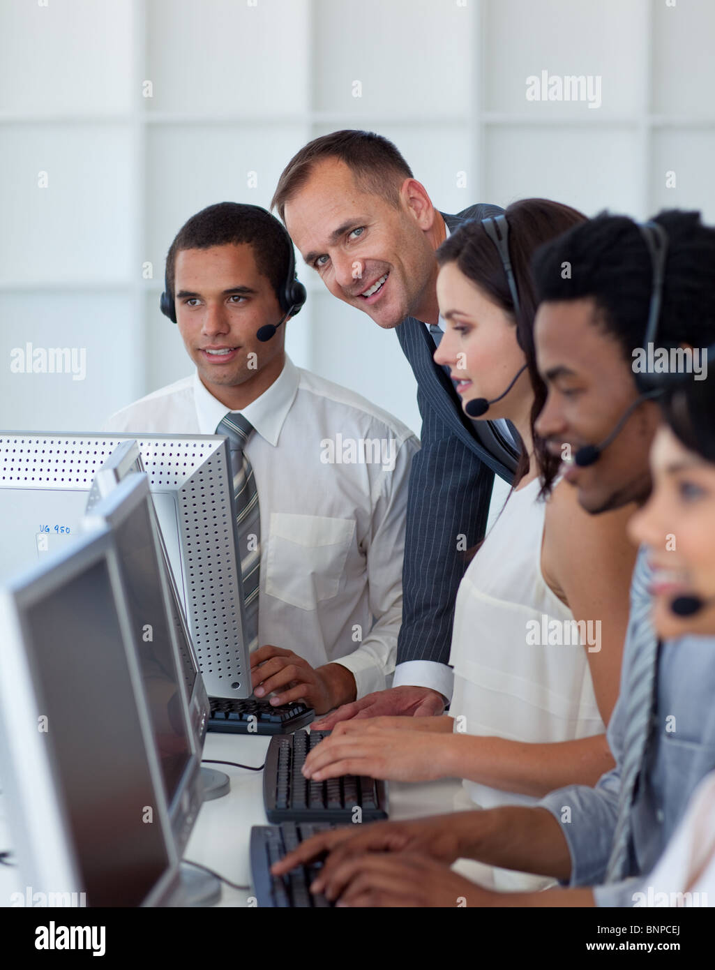 Business team working in a call center with a manager Stock Photo - Alamy
