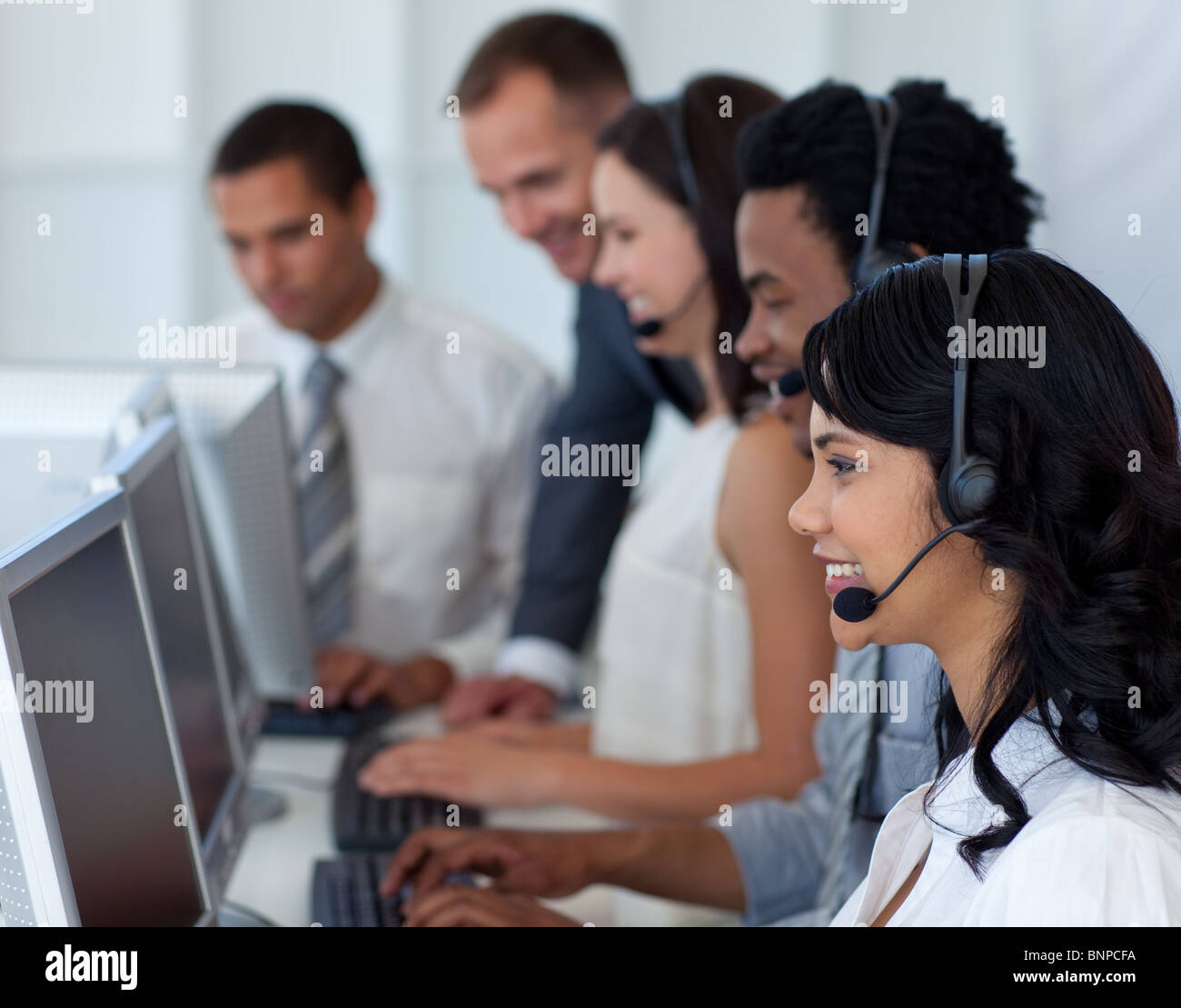 Businesswoman in a call center with her international team Stock Photo ...