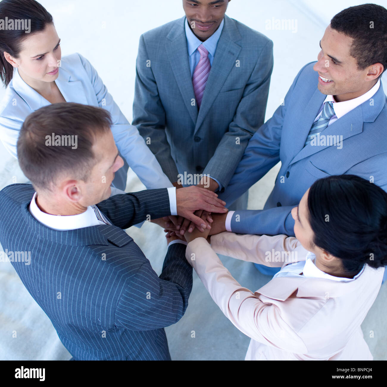 Business team with hands together Stock Photo - Alamy