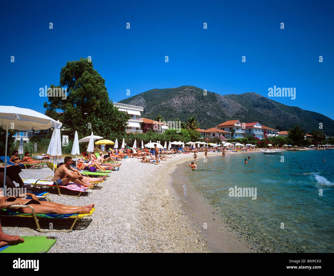 Beach scene at the picturesque resort of Nidri on the Greek island of ...