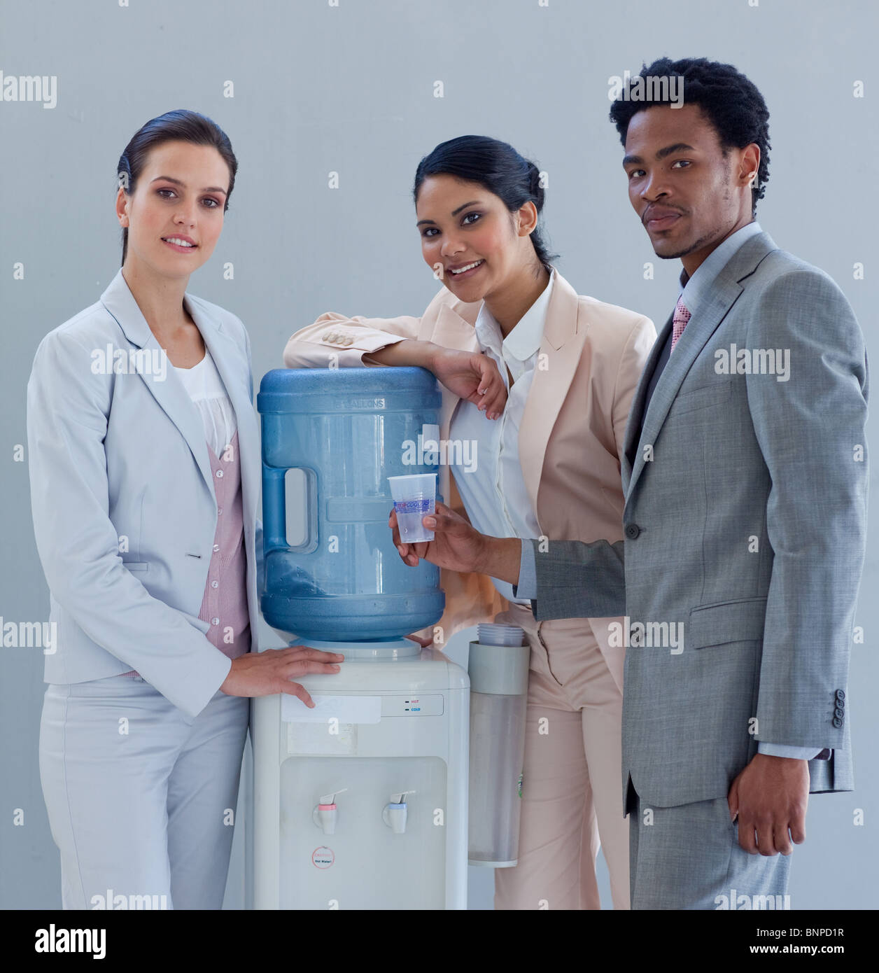 Business people with a water cooler in office Stock Photo - Alamy