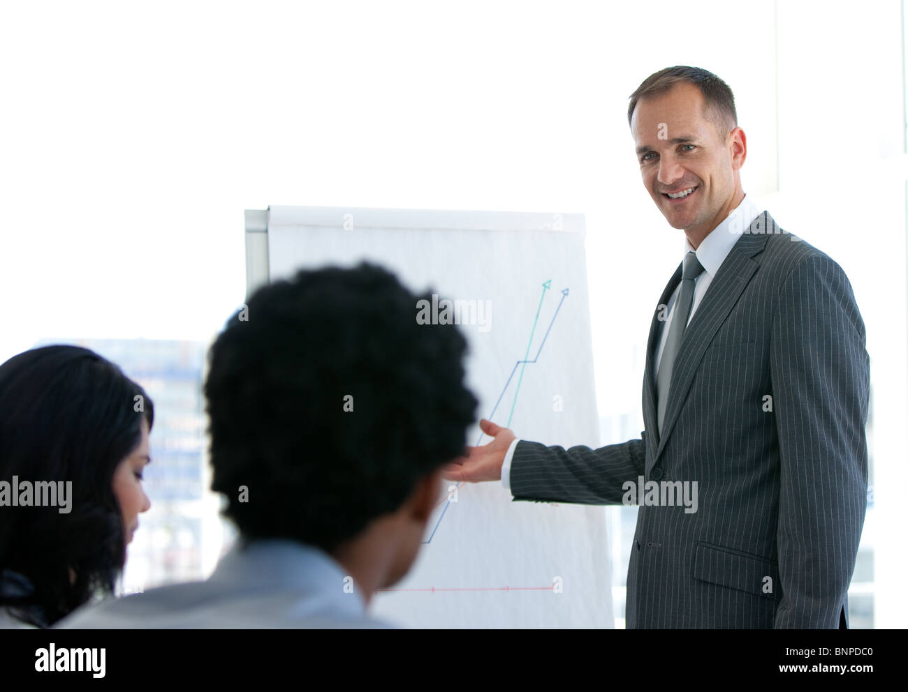 Manager giving a presentation to his team Stock Photo - Alamy