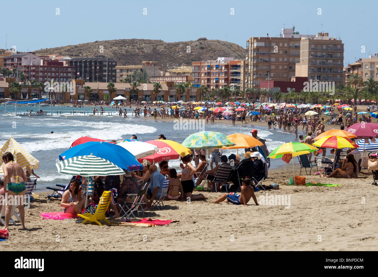 Crowded Beach in summer with parasols/umbrellas at Puerto de Mazarron ...