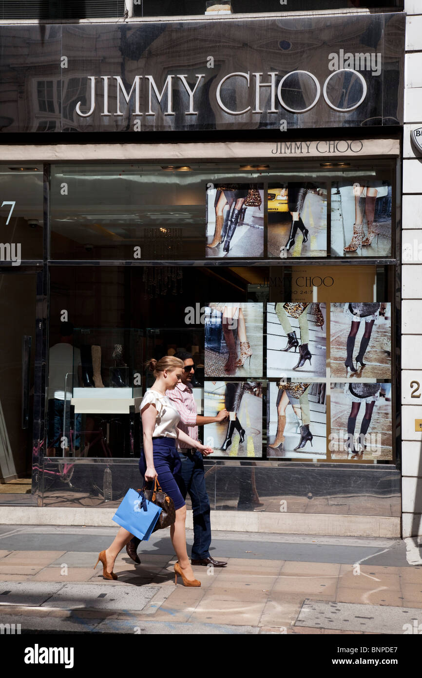 Shoppers pass high end shops on London's Bond Street. Known for it's ...