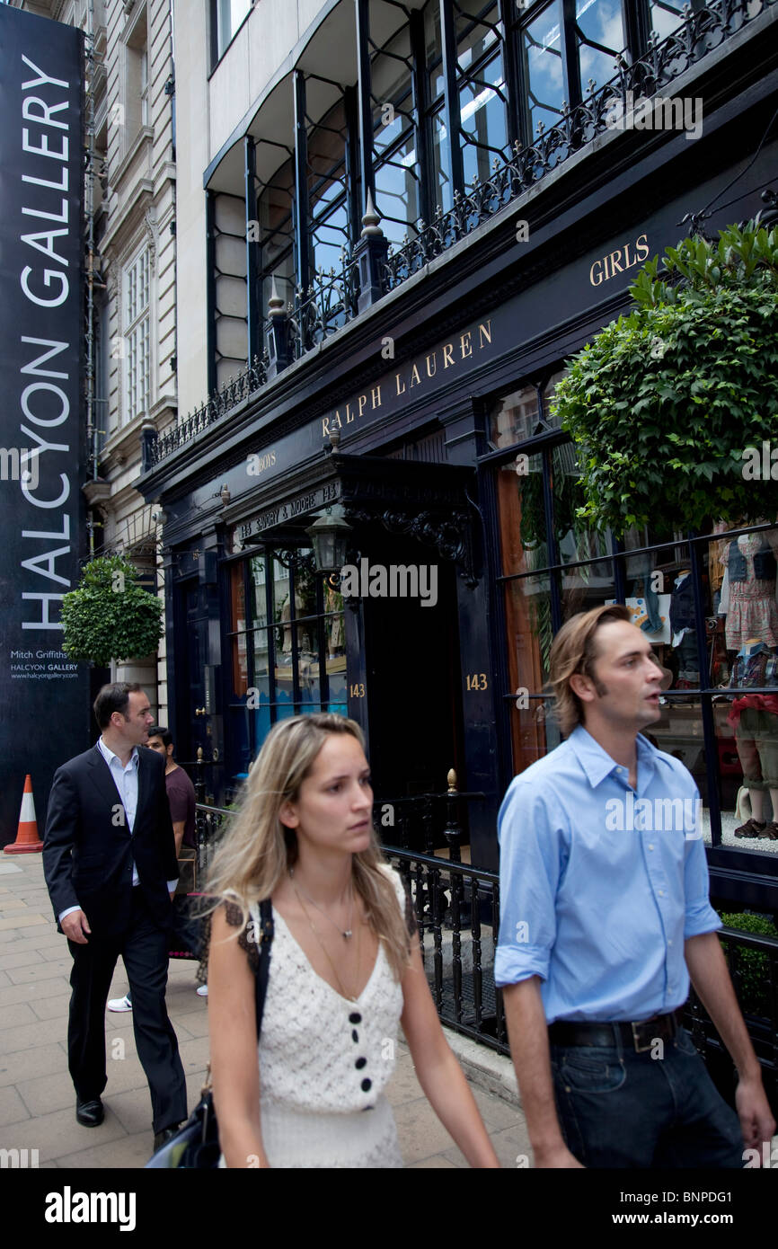 Shoppers pass high end shops on London's Bond Street. Known for it's ...