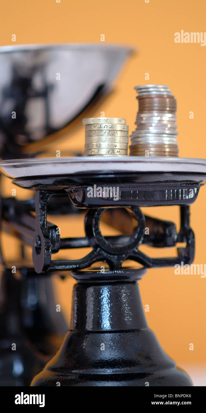 Weighing scale coins hi-res stock photography and images - Alamy