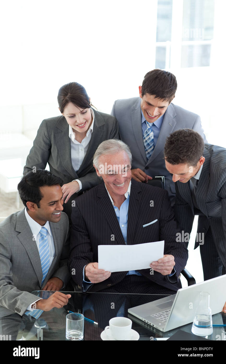 Businessman showing a contract to his team Stock Photo - Alamy