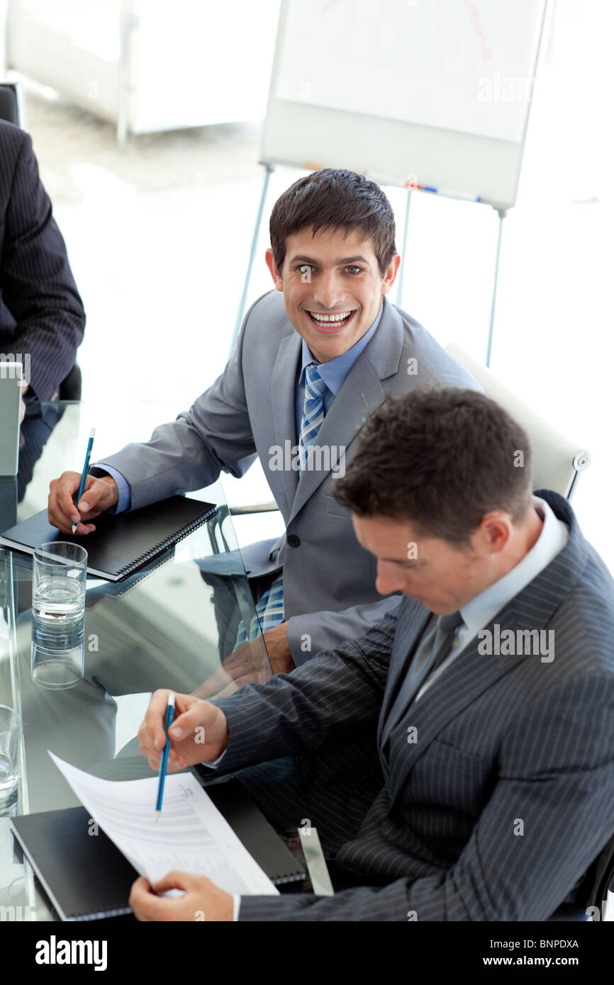 Young businessman smiling at the camera in a meeting Stock Photo - Alamy